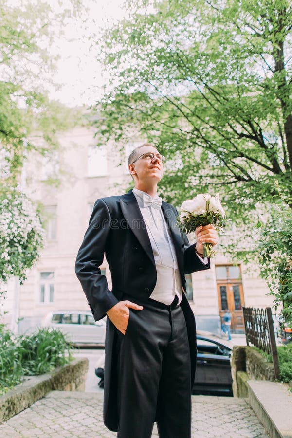 The Mysterious Charming Groom with the Wedding Bouquet. the Up View ...