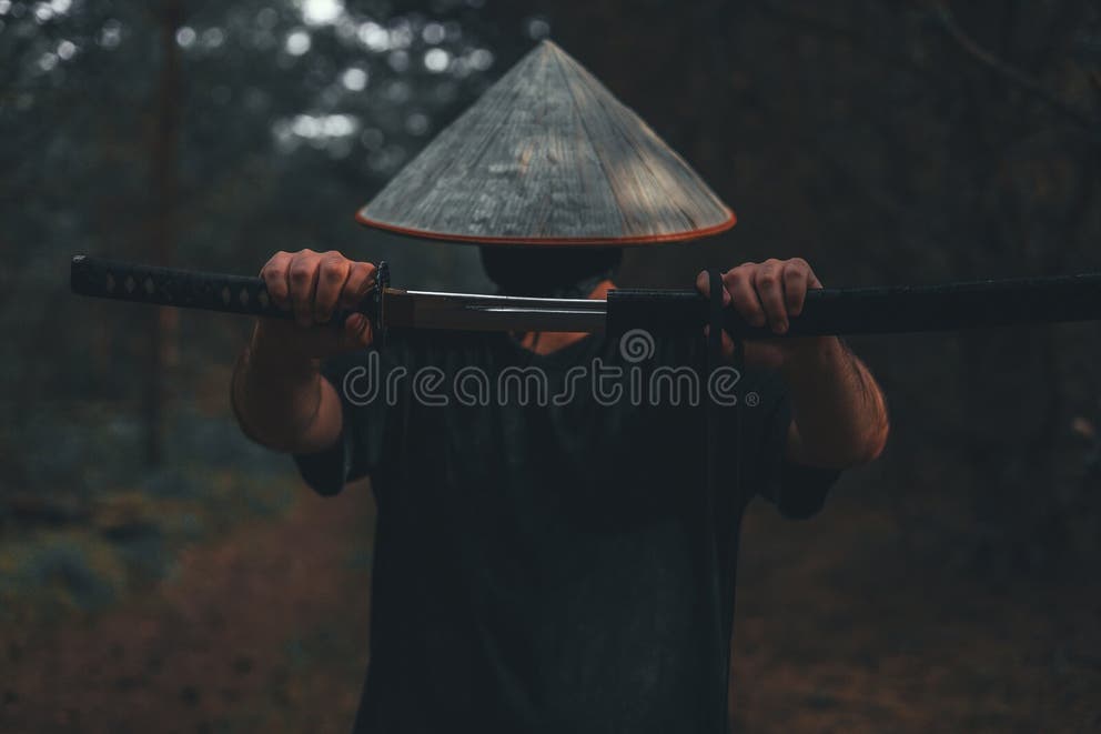 A Mysterious Samurai with a Conical Hat and a Katana in His Hands in ...