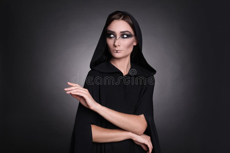 Mysterious Witch in Mantle with Hood on Dark Background Stock Image ...
