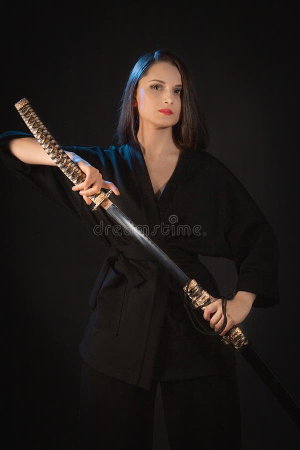 Mysterious Young Beautiful Woman with a Sharp Sword in Asian Style ...