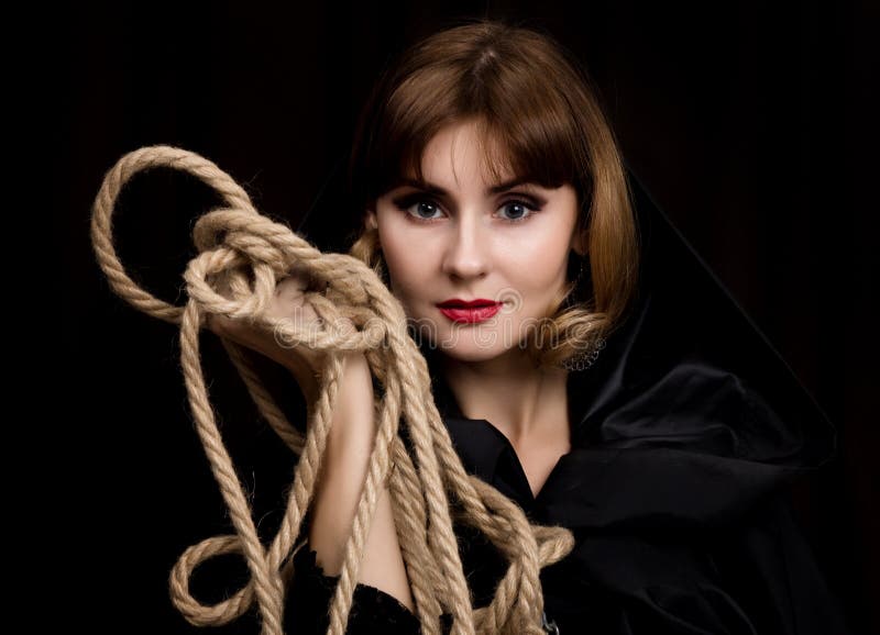 Mysterious Young Woman Holding Loop of the Rope. on a Dark Background ...