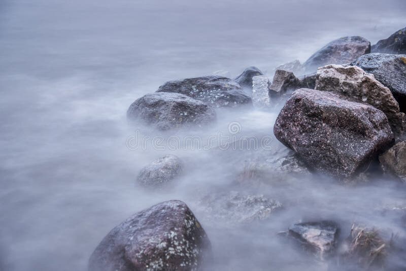 Mystery Blue Water and Stones Stock Image - Image of misty, idyllic ...