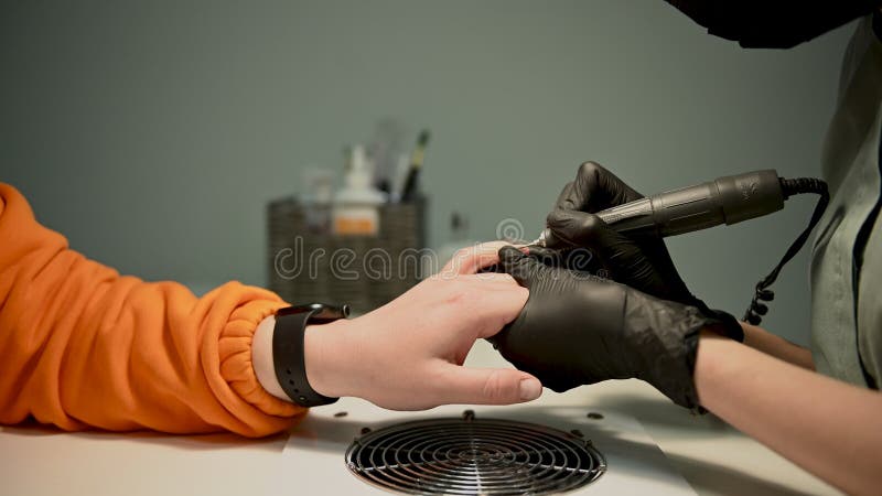 The Nail Master Removes the Previous Gel from the Nail Using a Cutter ...