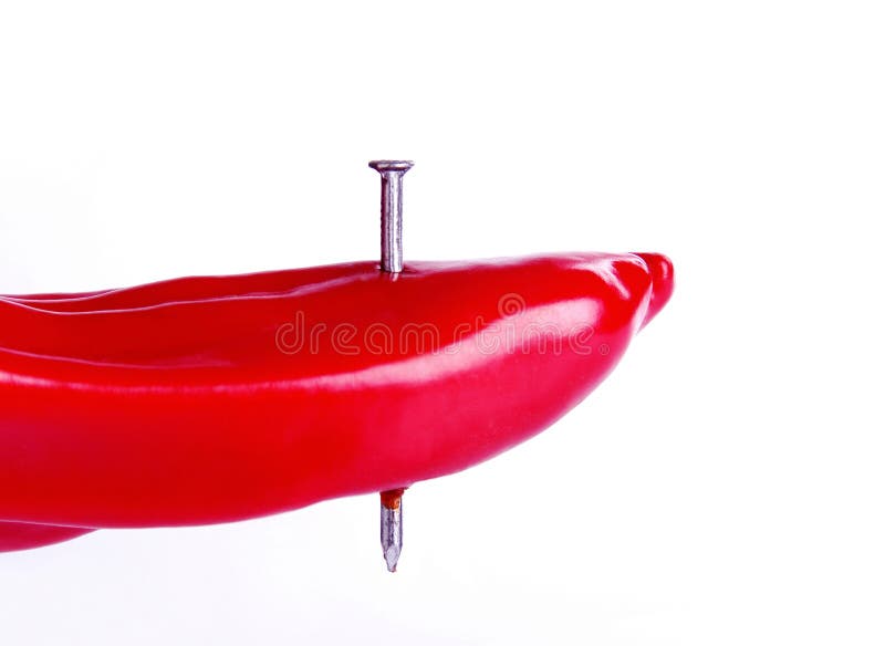 Nail Piercing through a Red Chilli Stock Photo - Image of objects ...