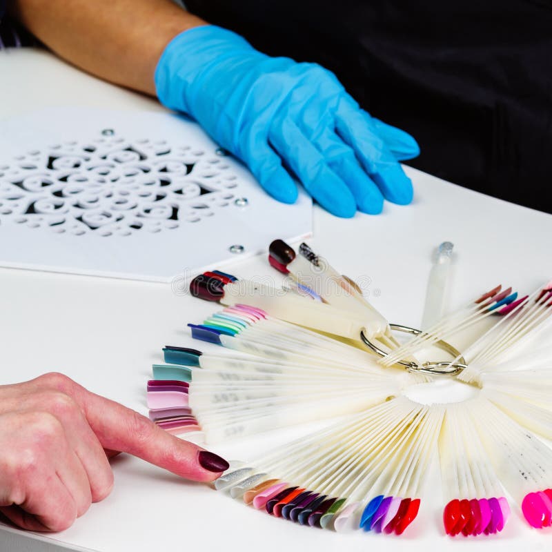 Nail Salon, Hands of Client and Master. Choice of Color for False Nails ...
