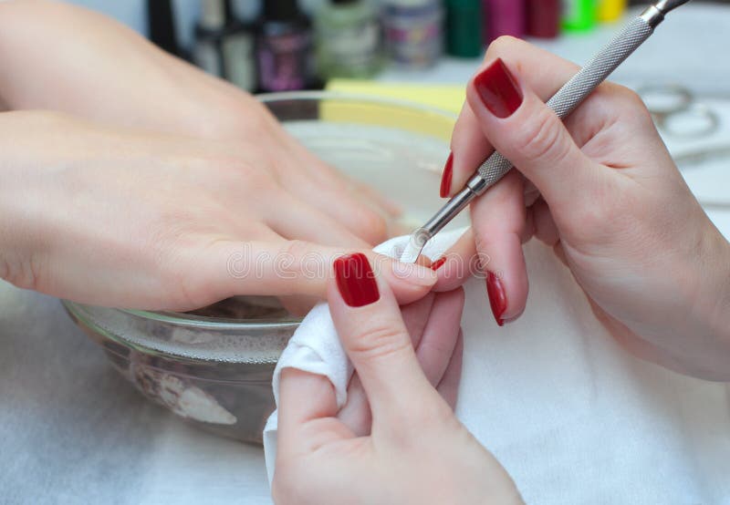 Nail Technician Cuts the Cuticles on the Hands in the Beauty Salon ...