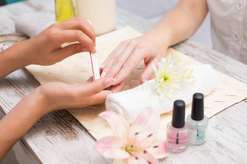 Nail Technician Giving Customer a Manicure Stock Photo - Image of ...