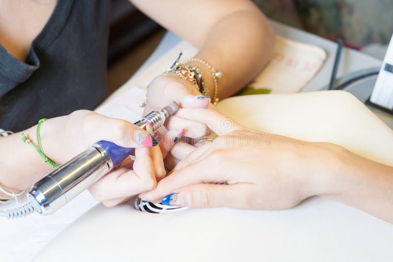 Nail Technician Sanding Nails Stock Photo - Image of buffer, female ...