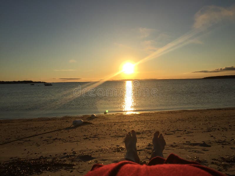 Relaxing on the Beach at Sunset Stock Photo - Image of rest, relaxing ...