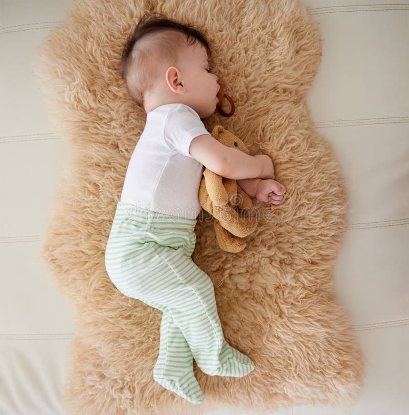 He always Naps after Feeding. an Adorable Baby Boy Taking a Nap. Stock ...