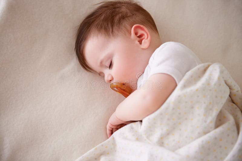 He always Naps after Feeding. an Adorable Baby Boy Taking a Nap. Stock ...