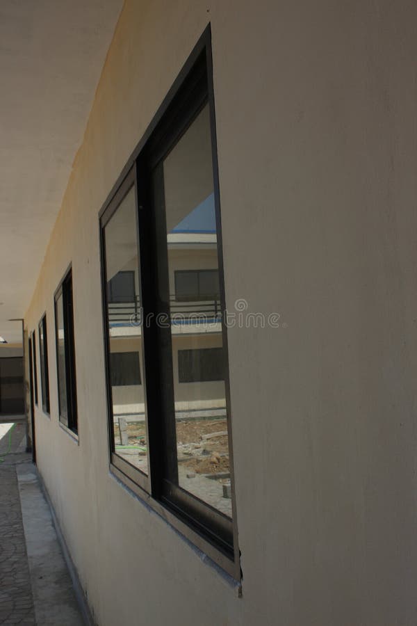 A Narrow Alley Lined with a Beige Building Features Several Rectangular ...