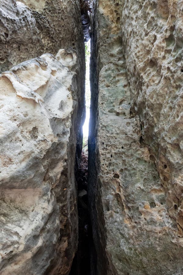 A Narrow Crevice in a Rock Wall with a Small Hole in it Stock Photo ...