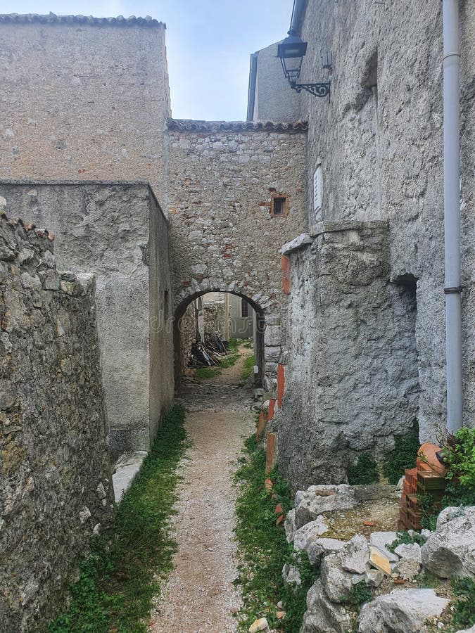 A Narrow Dirt Path through an Arch between the Walls of Ancient Stone ...