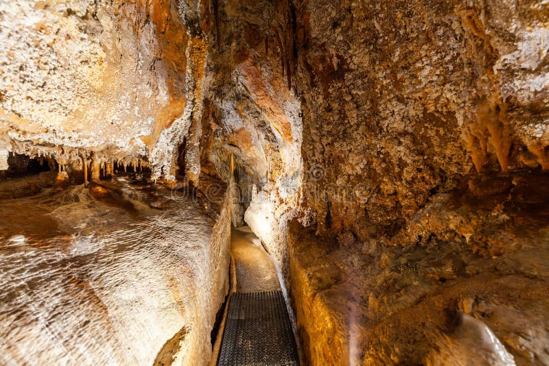 Narrow Cave Passage With Caver Stock Image - Image of cavern ...