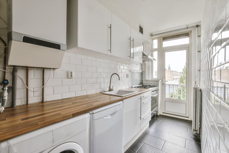 Narrow Long Kitchen with Wood Worktop Stock Photo - Image of clean ...