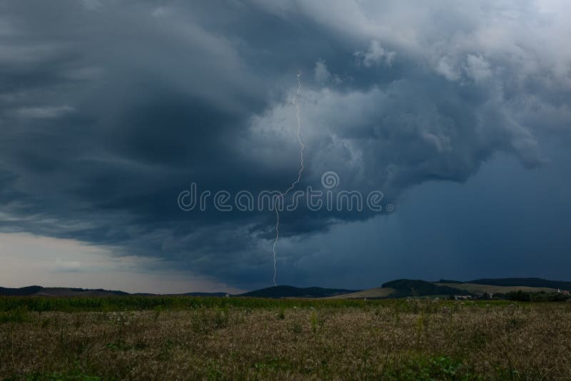 Narrow Long Vertical Lightning Bolt Shoots Out of a Dark Thundercloud ...