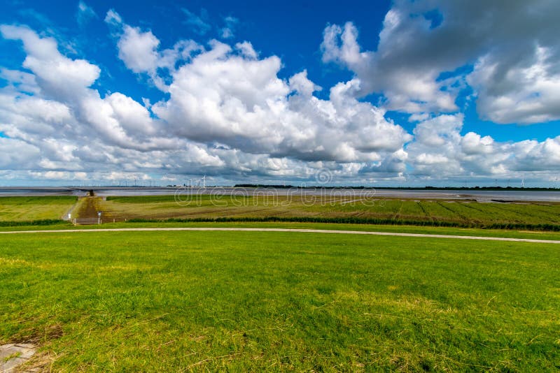 Narrow Path Leading through a Green Rural Field Under a Bright Blue Sky ...