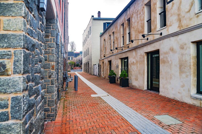 Narrow Paved Brick Street between Brick Houses Stock Photo - Image of ...