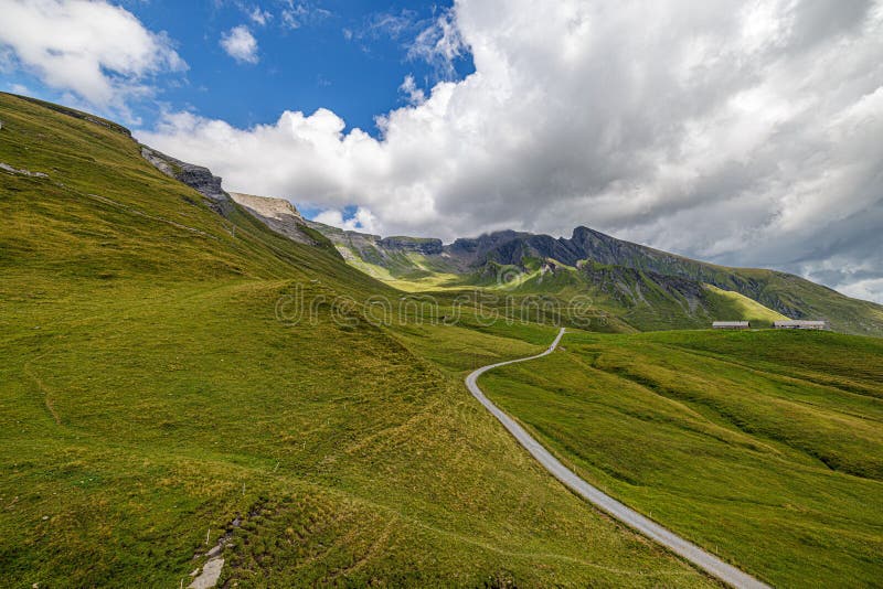 Narrow Road in Mountains Area Covered with Grass Under Cloudy Sky Stock ...