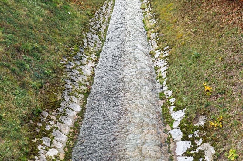 Narrow Stone-lined Stream Flowing through Lush Green Landscape Spring ...