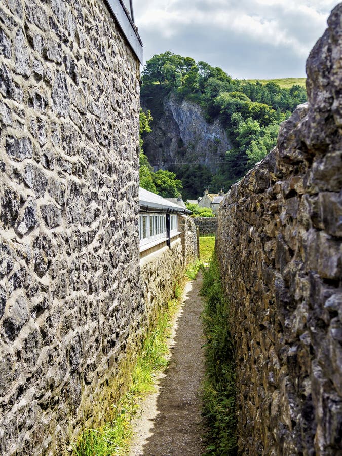 Narrow Stone Pathway between Rustic Buildings during a Bright Summer ...