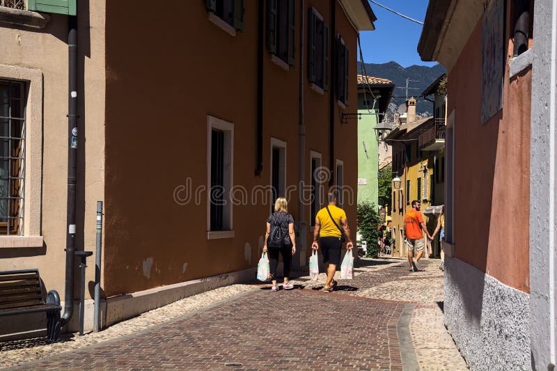 Narrow Street with Shops and People Passing by in a Small Town ...