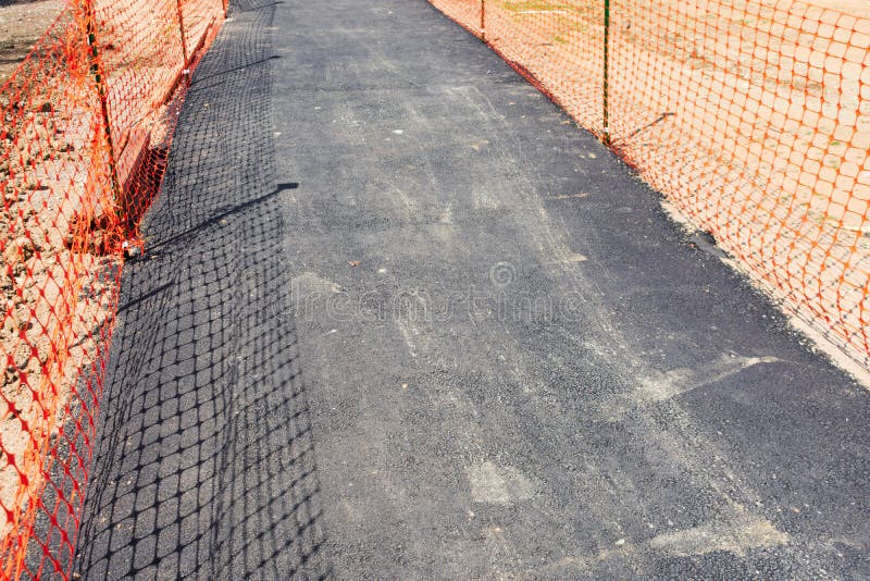 A Narrow Temporary Asphalt Path through a Dirt Construction Site Stock ...