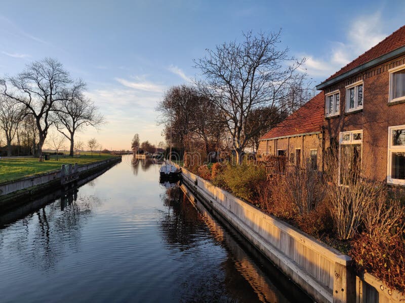 Narrow Water Canal Surrounded by Trees and Houses Stock Photo - Image ...