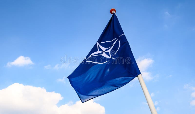 NATO flag in sky stock image. Image of path, clean, symbol - 286647165