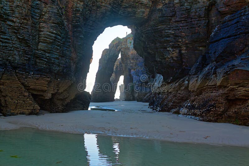 Natural arches at beach stock photo. Image of cavern - 71283880