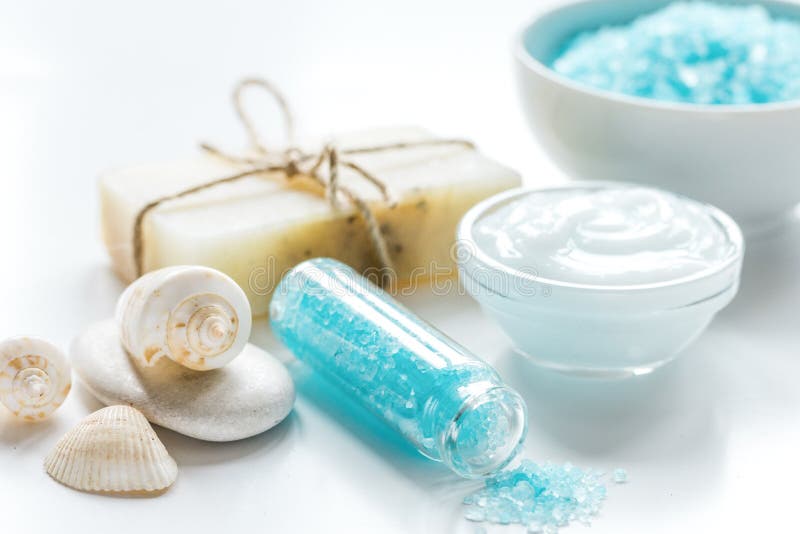 Blue Bath Salt, Body Cream and Shells for Spa on White Table Background ...
