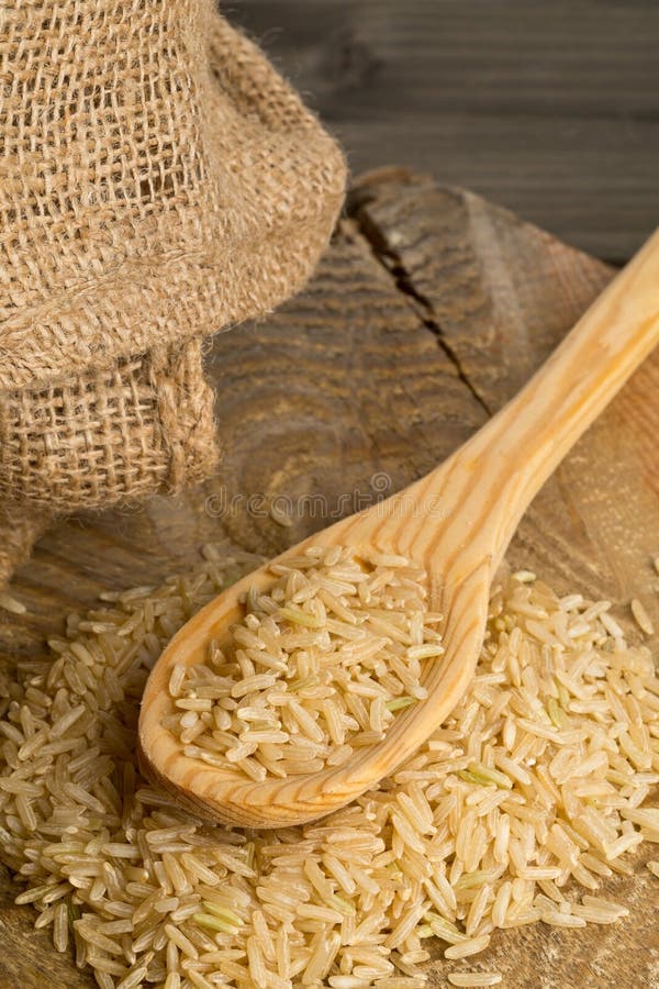 Natural Brown Uncooked Rice on Wooden Spoon Stock Photo - Image of ...