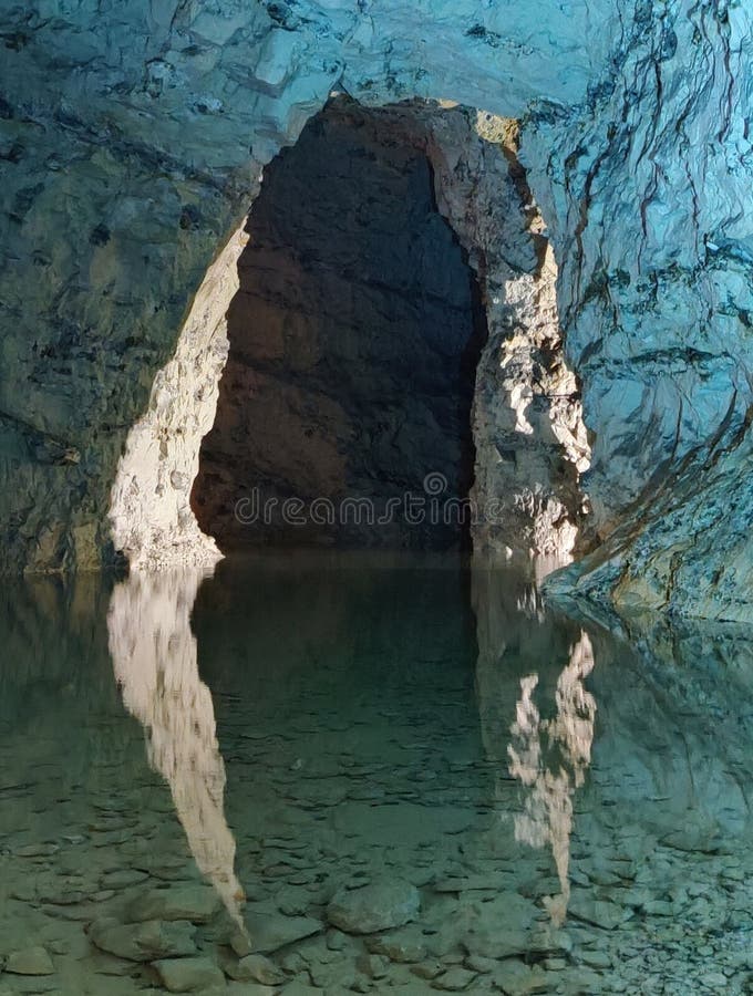 Natural Cave with Clear Water Reflections Stock Image - Image of ...