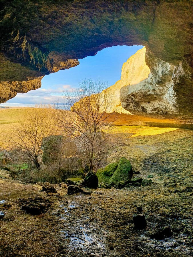 Natural cave in mountains stock photo. Image of tree - 210497034
