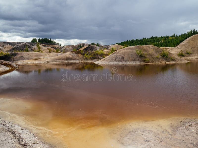 Natural Clay Quarry. Red Lake because of the Clay Stock Photo - Image ...