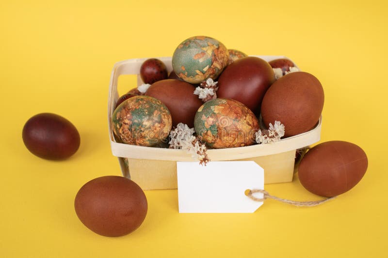 Natural Dyed Easter Eggs in Basket with Tag on Yellow Background Stock ...