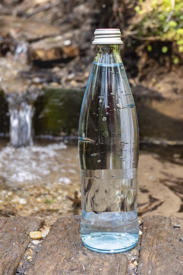 Natural Ecological Spring Water. Glass Bottle with Cold Spring Water ...