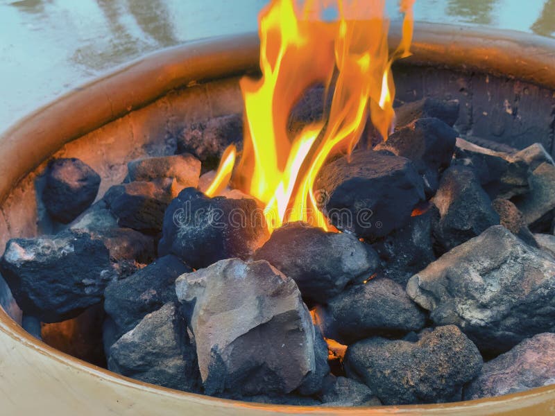 Natural Gas Fire Pit with Ceramic Rocks and Flames Stock Photo - Image ...