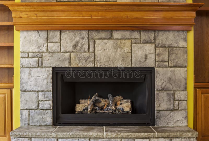 Natural Gas Insert Fireplace with Stone and Wood Stock Image - Image of ...