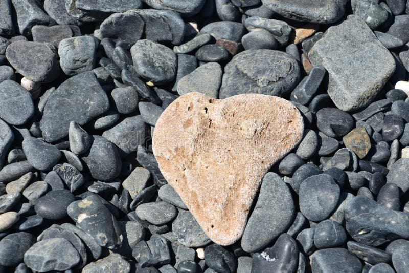 Natural Heart Shaped Sea Stone on Rocks Stock Photo - Image of concept ...