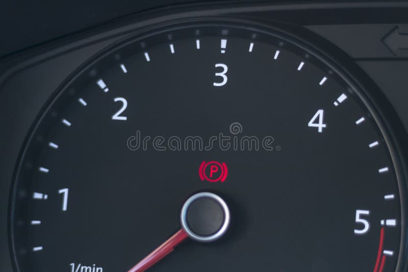 Natural Light. the Dashboard of the Car. the Handbrake Indicator is on ...