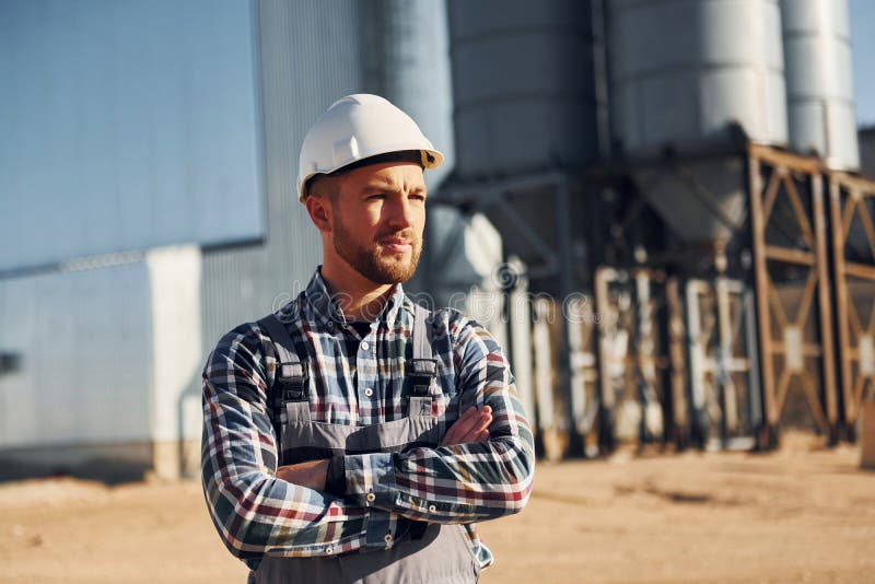 Natural Lighting. Construction Worker in Uniform is Outdoors Near the ...
