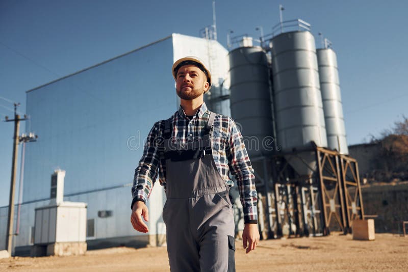 Natural Lighting. Construction Worker in Uniform is Outdoors Near the ...