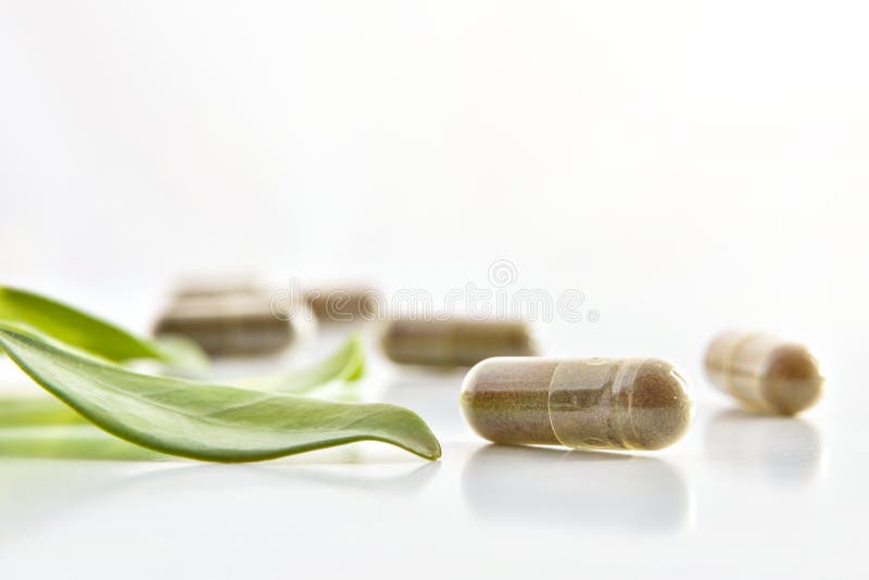 Natural Medicine Capsules and Plant on White Table Front Stock Photo ...