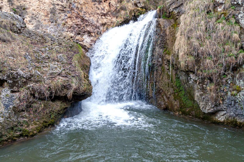 A Mountain Waterfall Flowing into a Rocky Pool. Stock Image - Image of ...