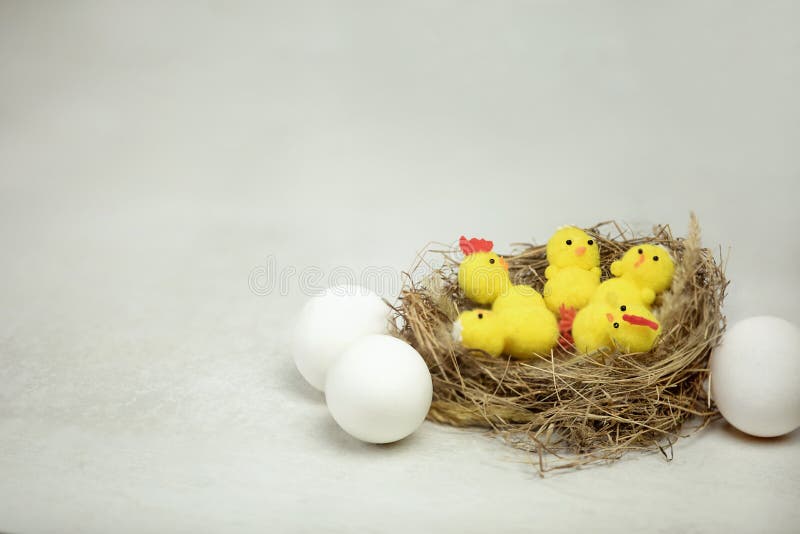 A Natural Nest with Eggs and Decorative Chickens Inside on a White ...