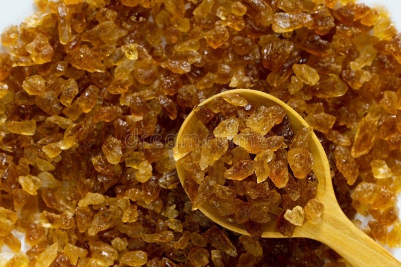 Organic Brown Crystal Rock Sugar in Wooden Spoon Over Brown Rock Sugar ...