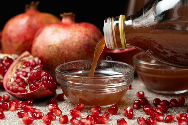 Natural Pomegranate Vinegar Pour from Bottle into Glass Bowl Stock ...