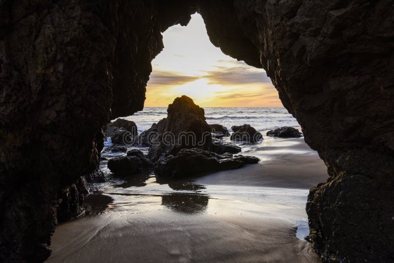 A Natural Rock Formation Frames the Setting Sun. Stock Image - Image of ...